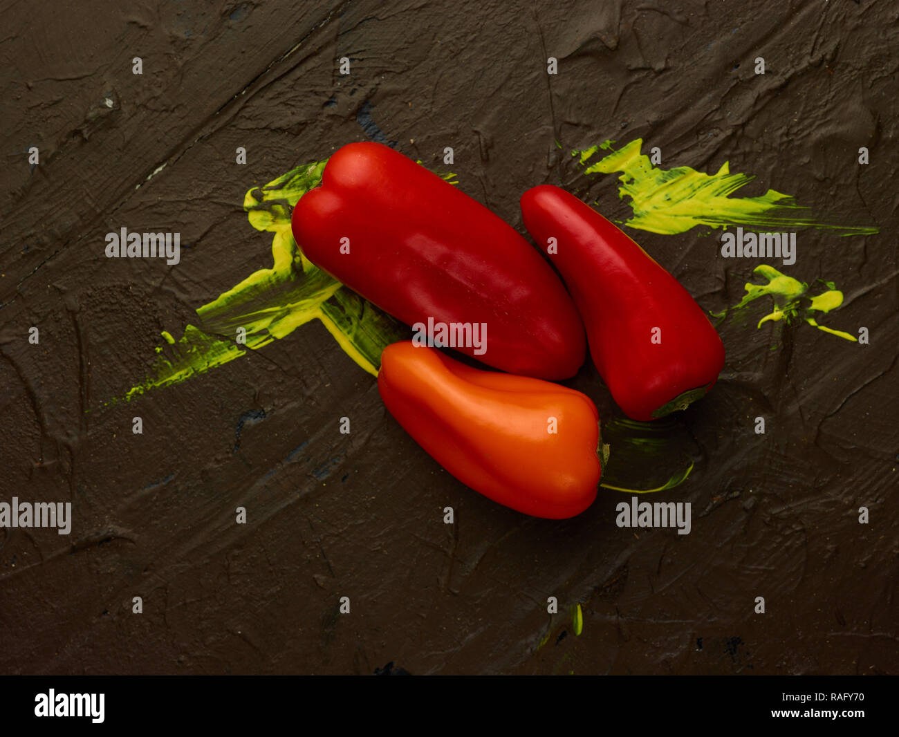 Mini sweet capsicum pepper against dark background with yellow flecks ...