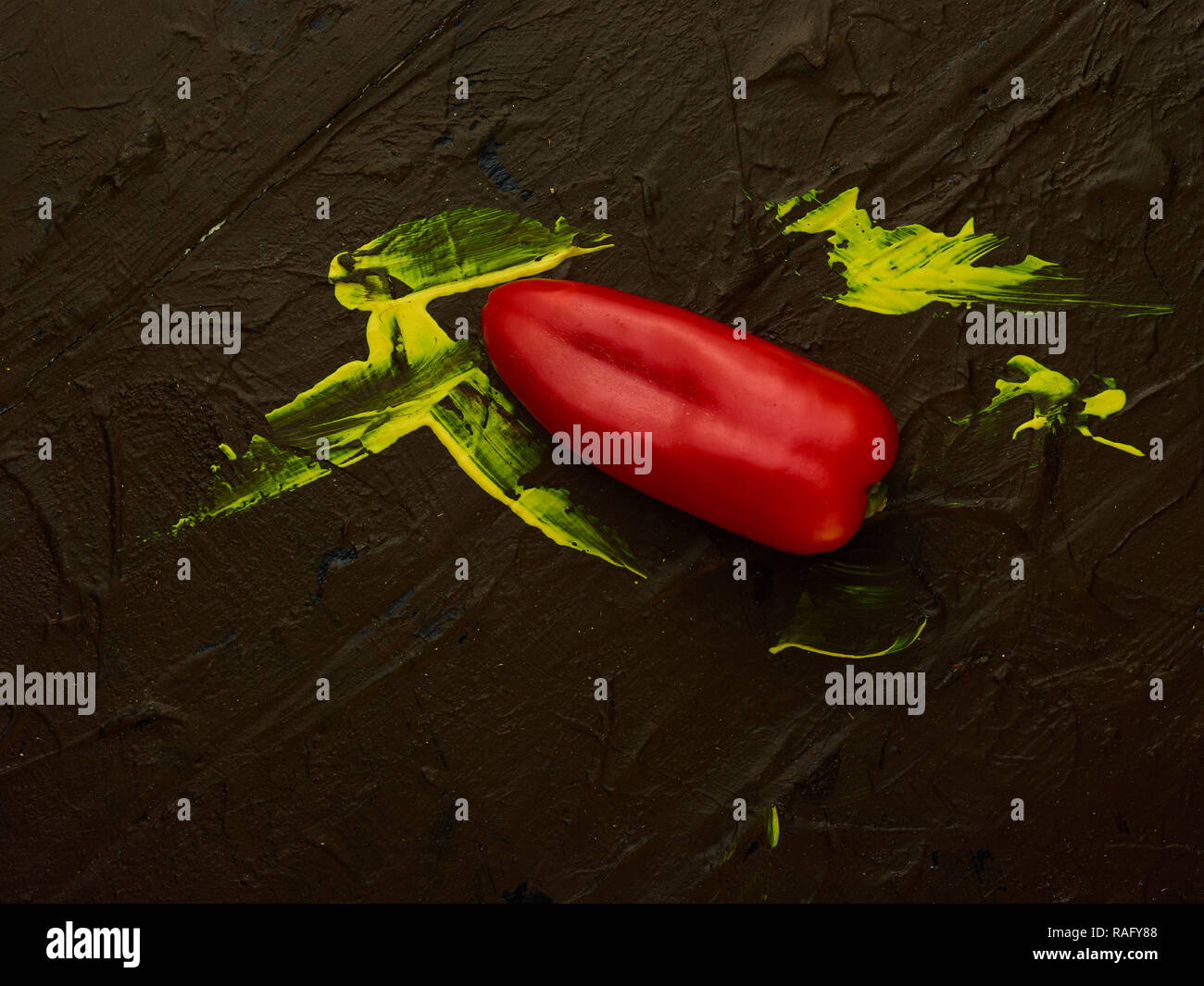 Mini sweet capsicum pepper against dark background with yellow flecks ...