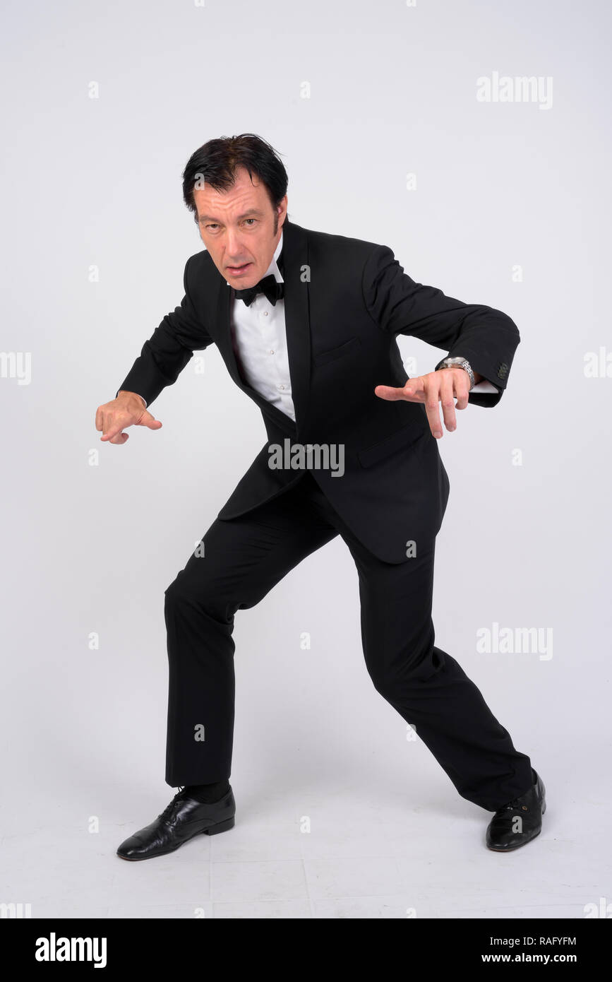 Full body shot of mature handsome businessman as secret agent Stock ...