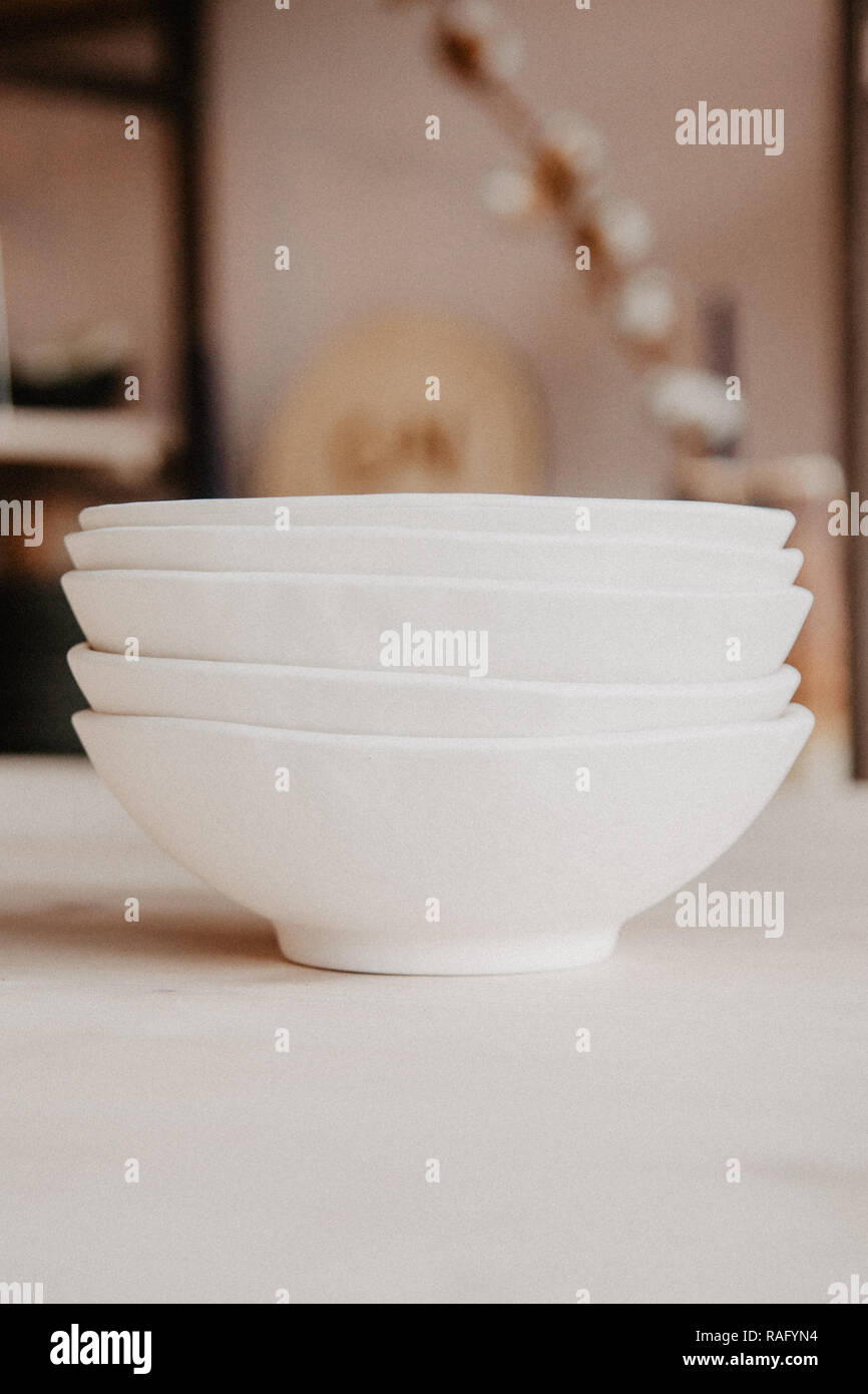 Stack of ceramic plates on cozy background Stock Photo - Alamy