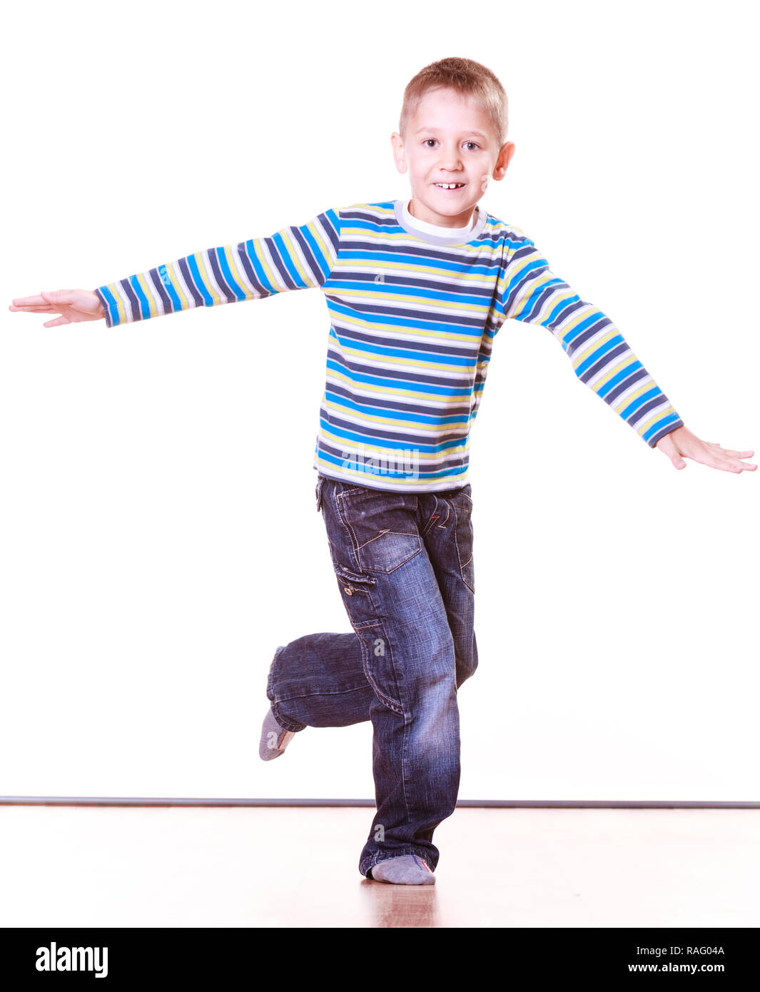 Free time, fun and expression. Little boy play alone indoors make silly ...