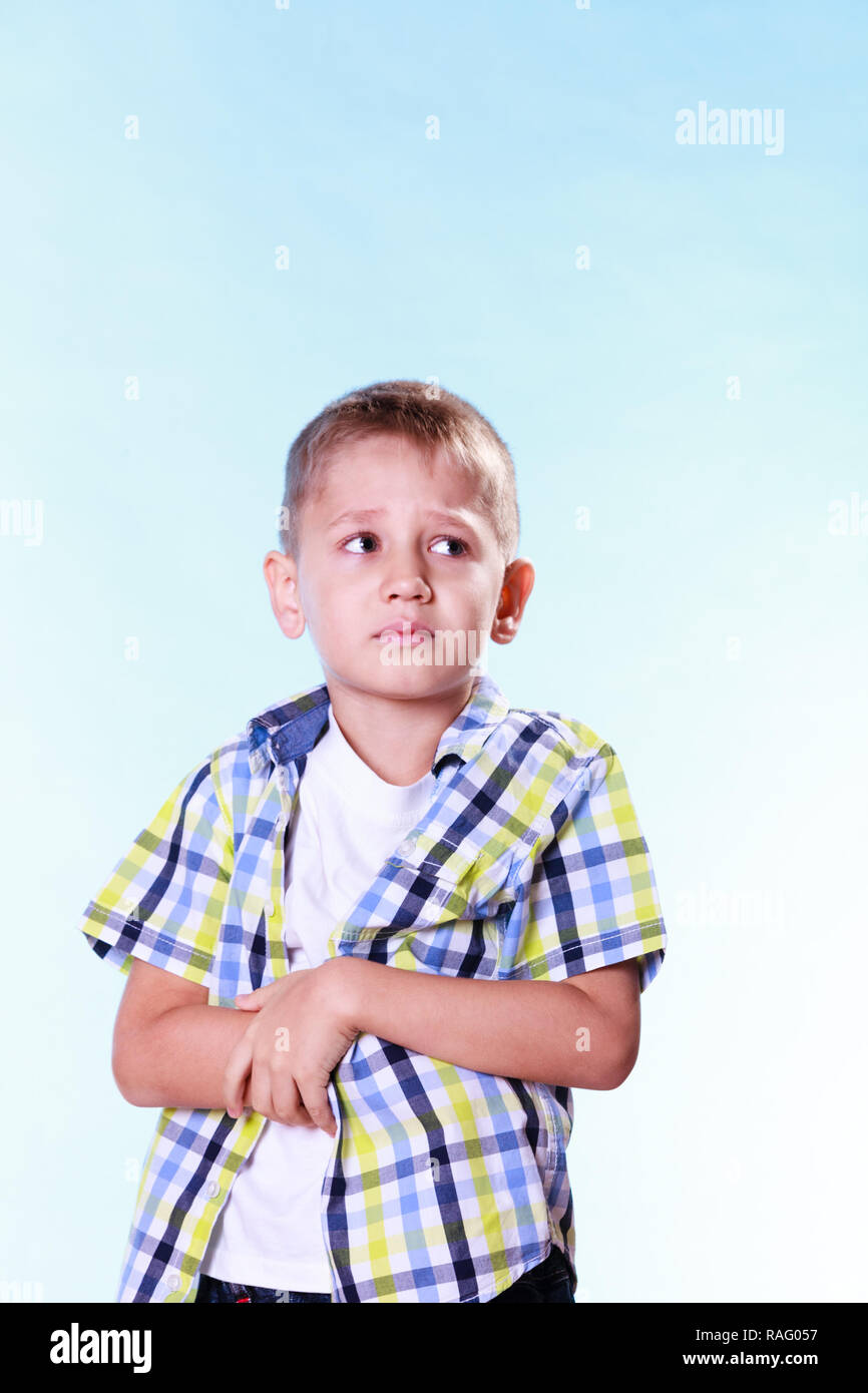 Independence and emotions. Shy little boy express self conscious hold ...