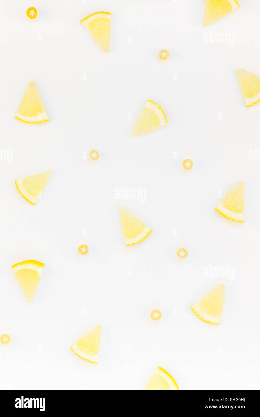 Creative flatlay overhead top view citrus lemon slices pattern frame white table background with ...