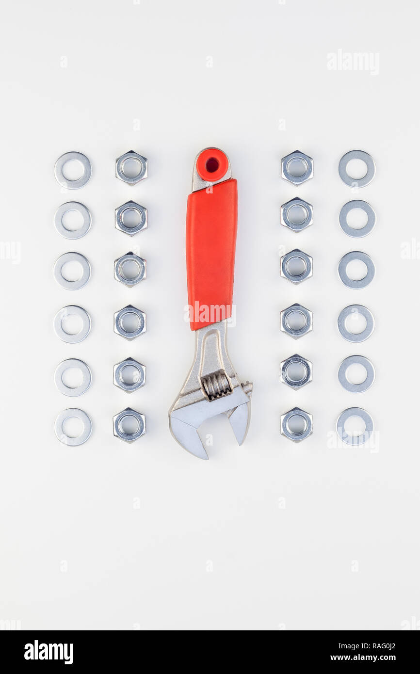 Creative knolling Flat lay of metal nuts and spanner on white ...
