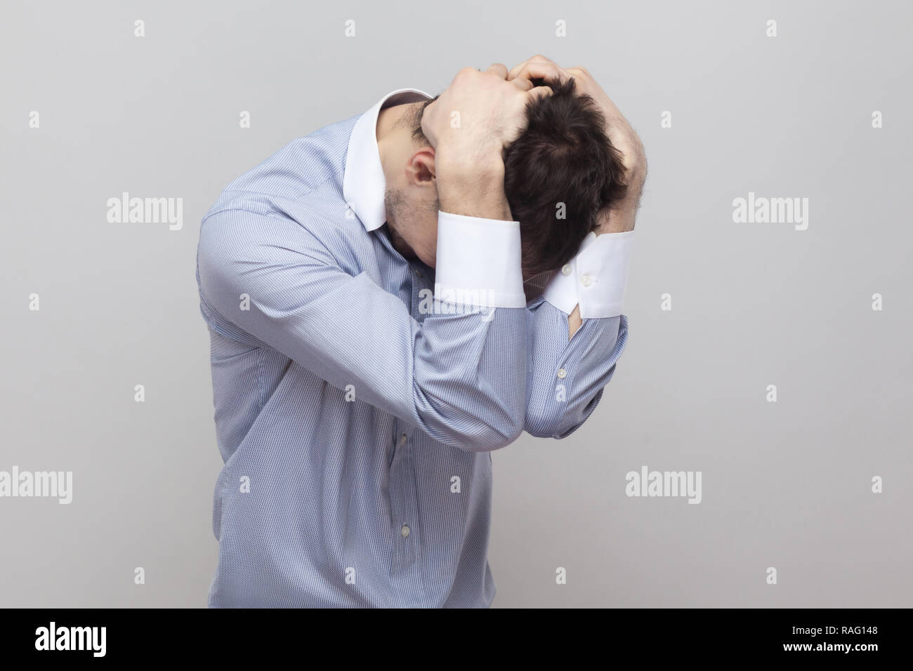 Worker holding head in shame hi-res stock photography and images - Alamy