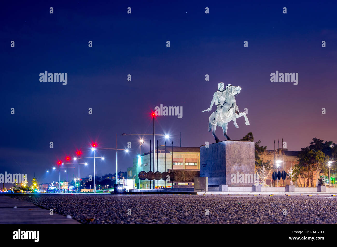 Statue of the famous king Alexander the Great at night, in the harbor ...