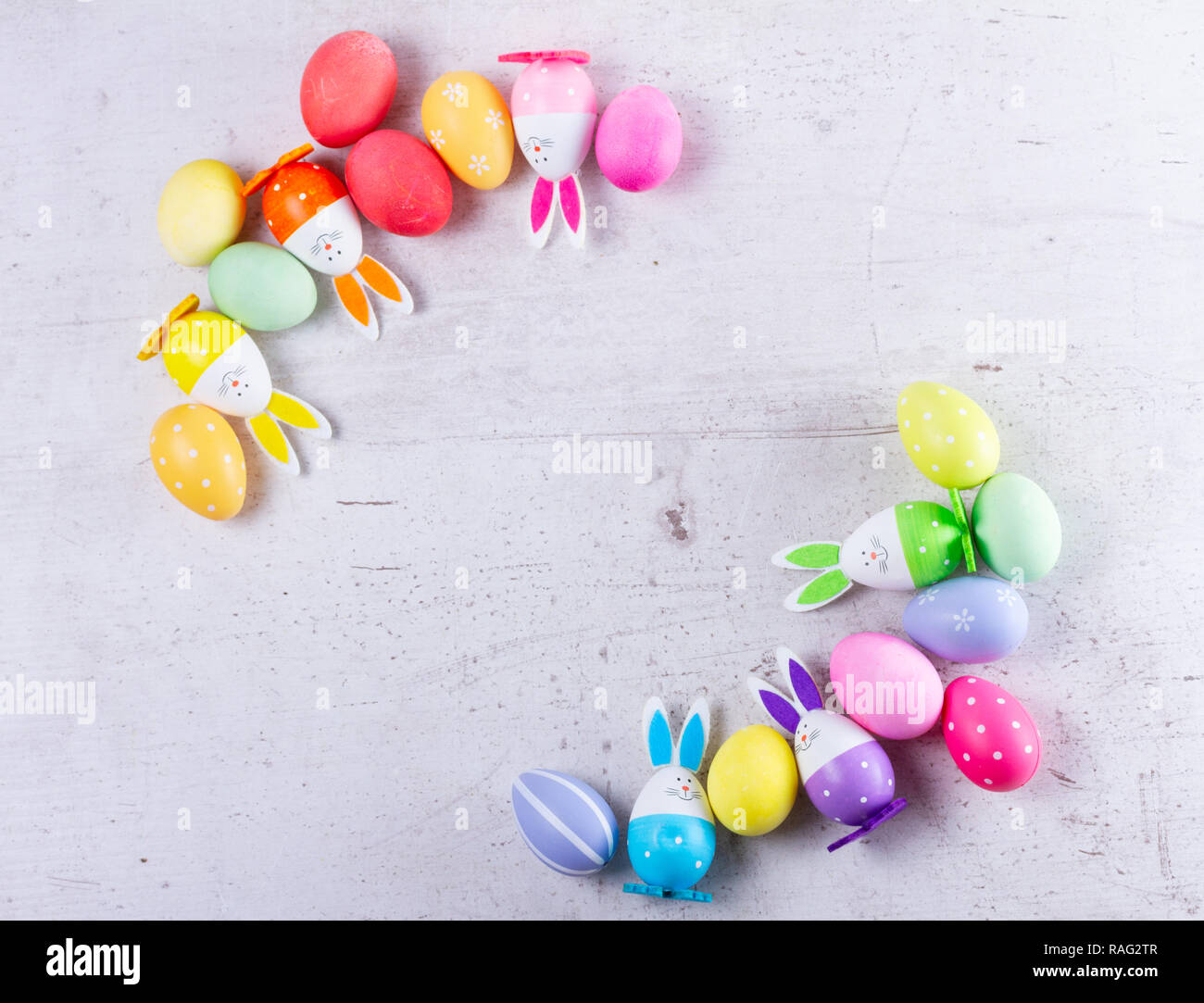 Easter frame with colored eggs and bunnies, top view Stock Photo - Alamy