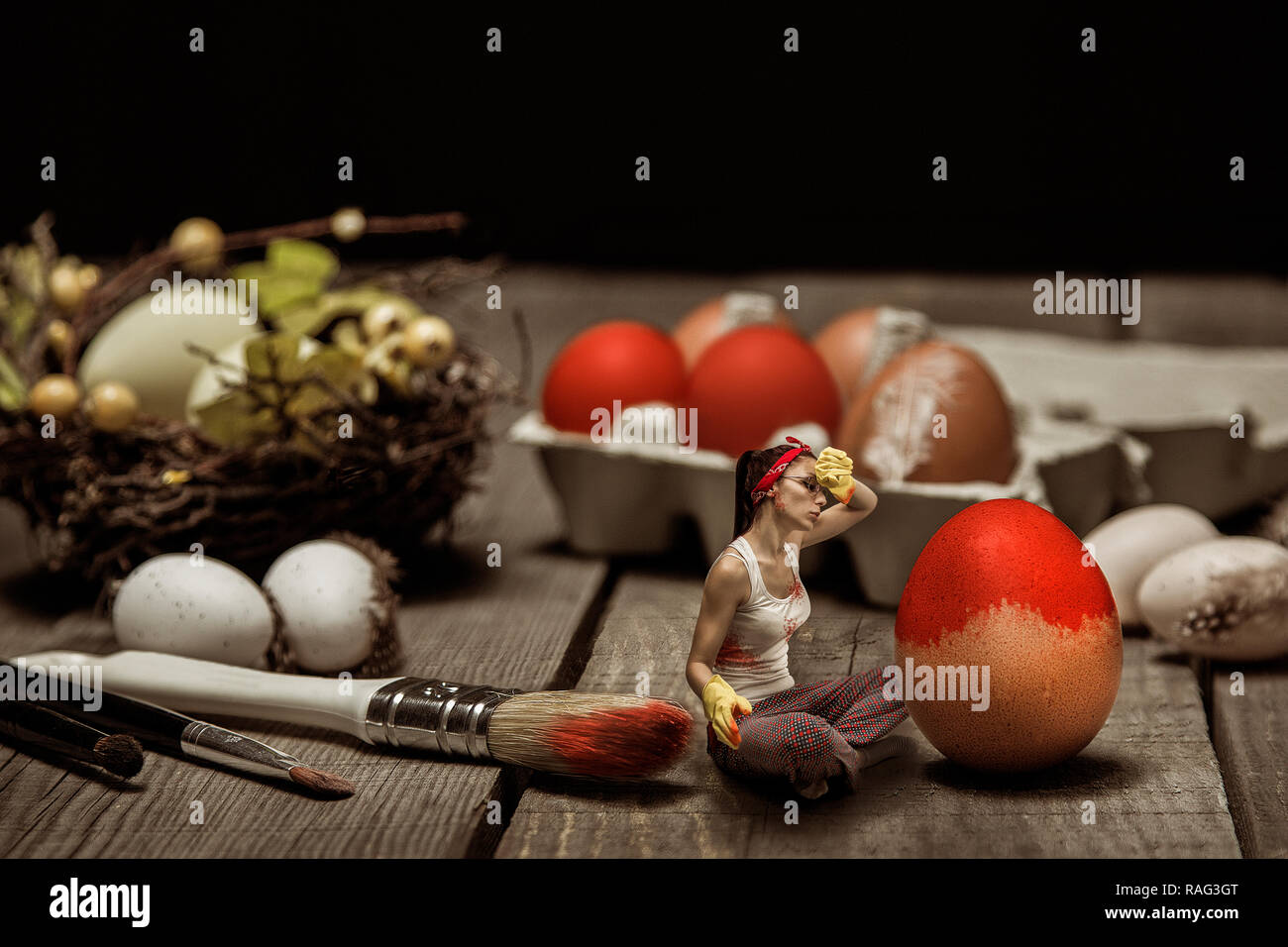Surreal photo of girl painting big eggs in red on Easter day Stock ...