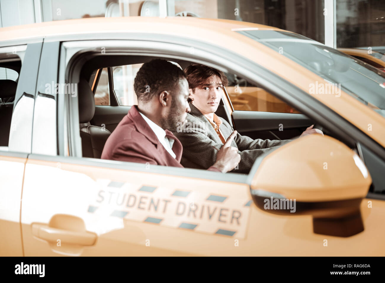 Inexperienced young driver feeling worried sitting in the car Stock ...