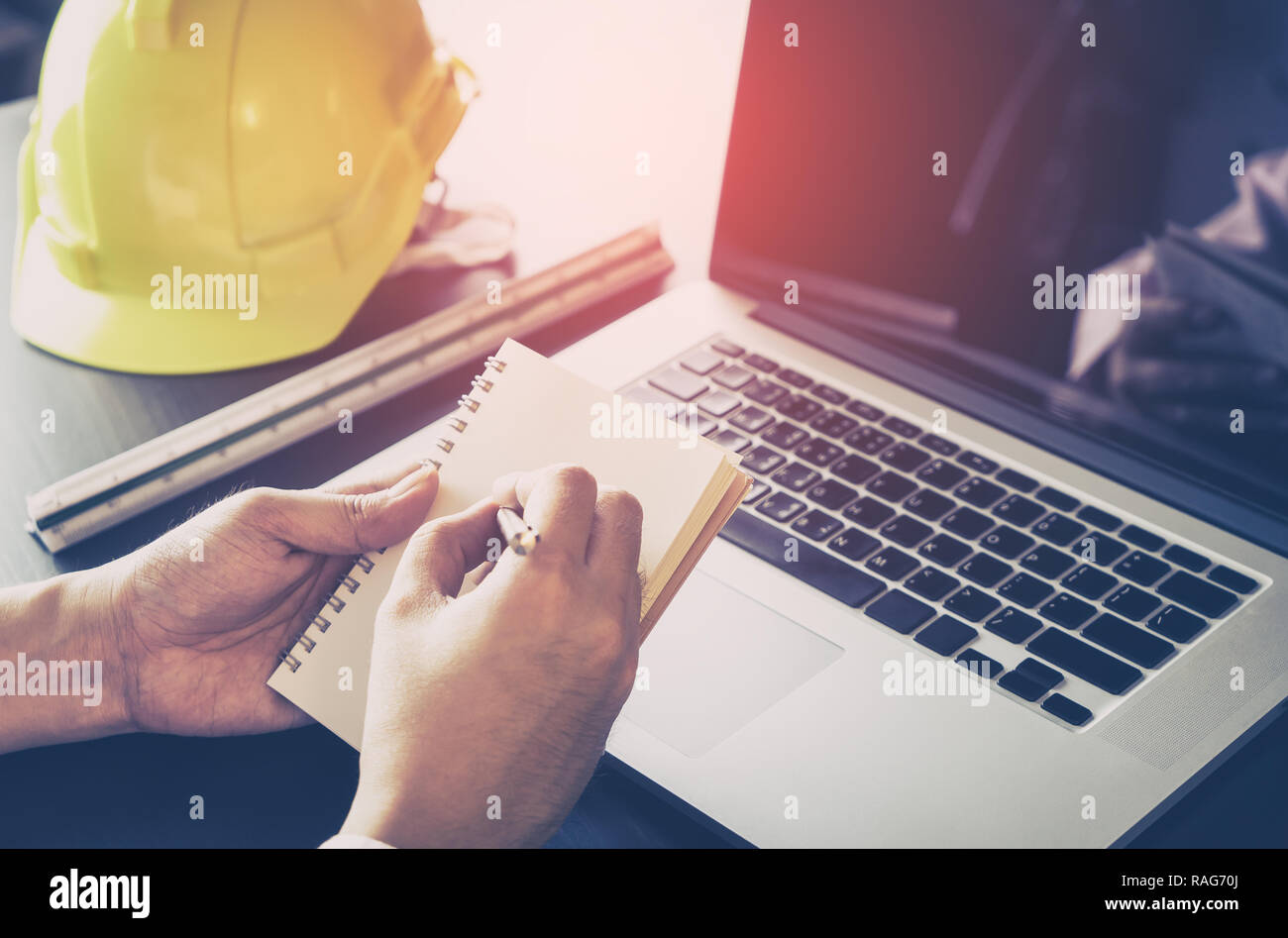 Engineer is making plan on blank notebook in office Stock Photo - Alamy