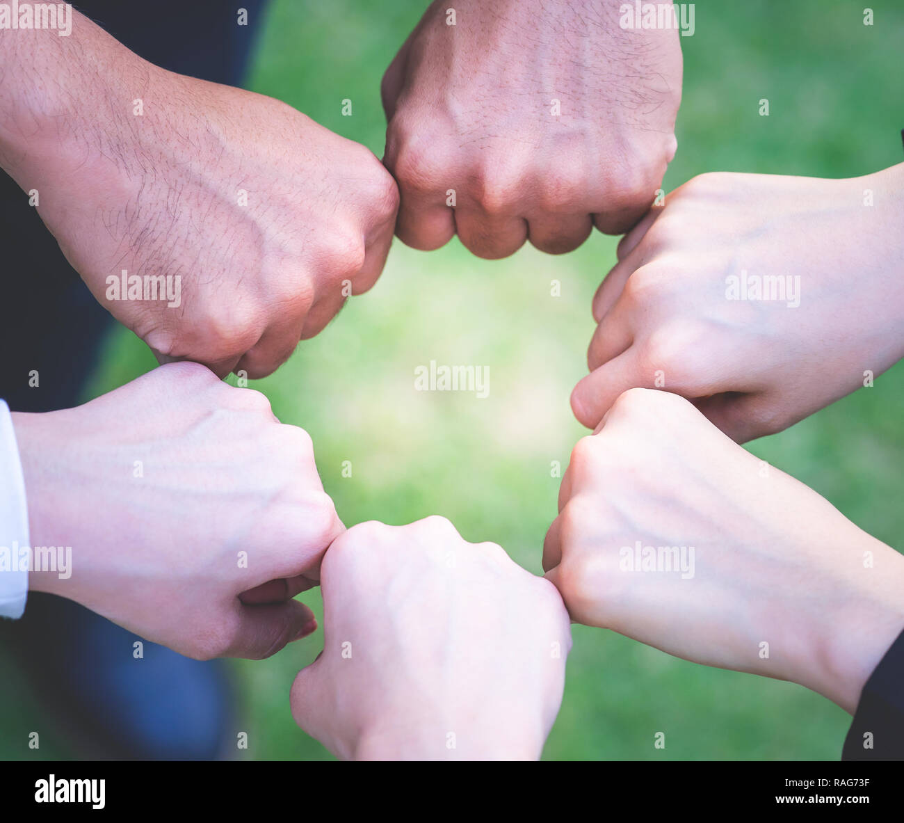 Team fist bump together to form team spirit concept Stock Photo - Alamy