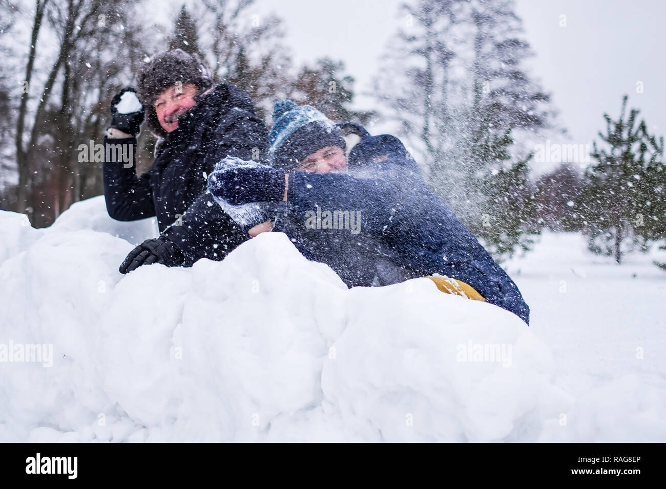 A senior man and his young son throwing a snowball Stock Photo - Alamy
