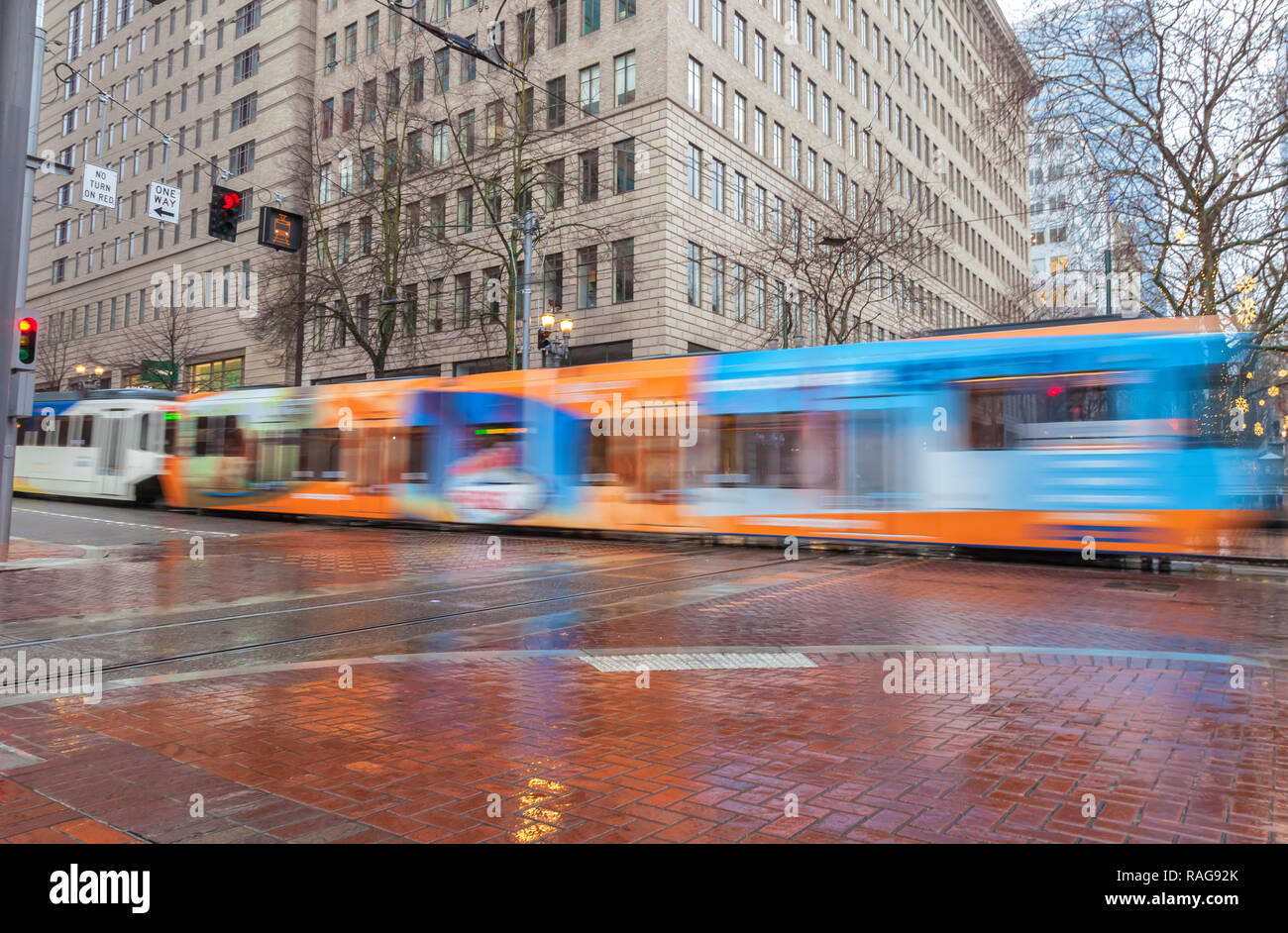 MAX Light Rail moves through the street of Portland, Oregon during the ...