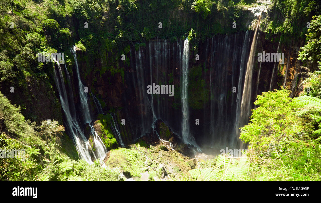 waterfall Coban Sewu in tropical forest, Java Indonesia. tumpak sewu ...