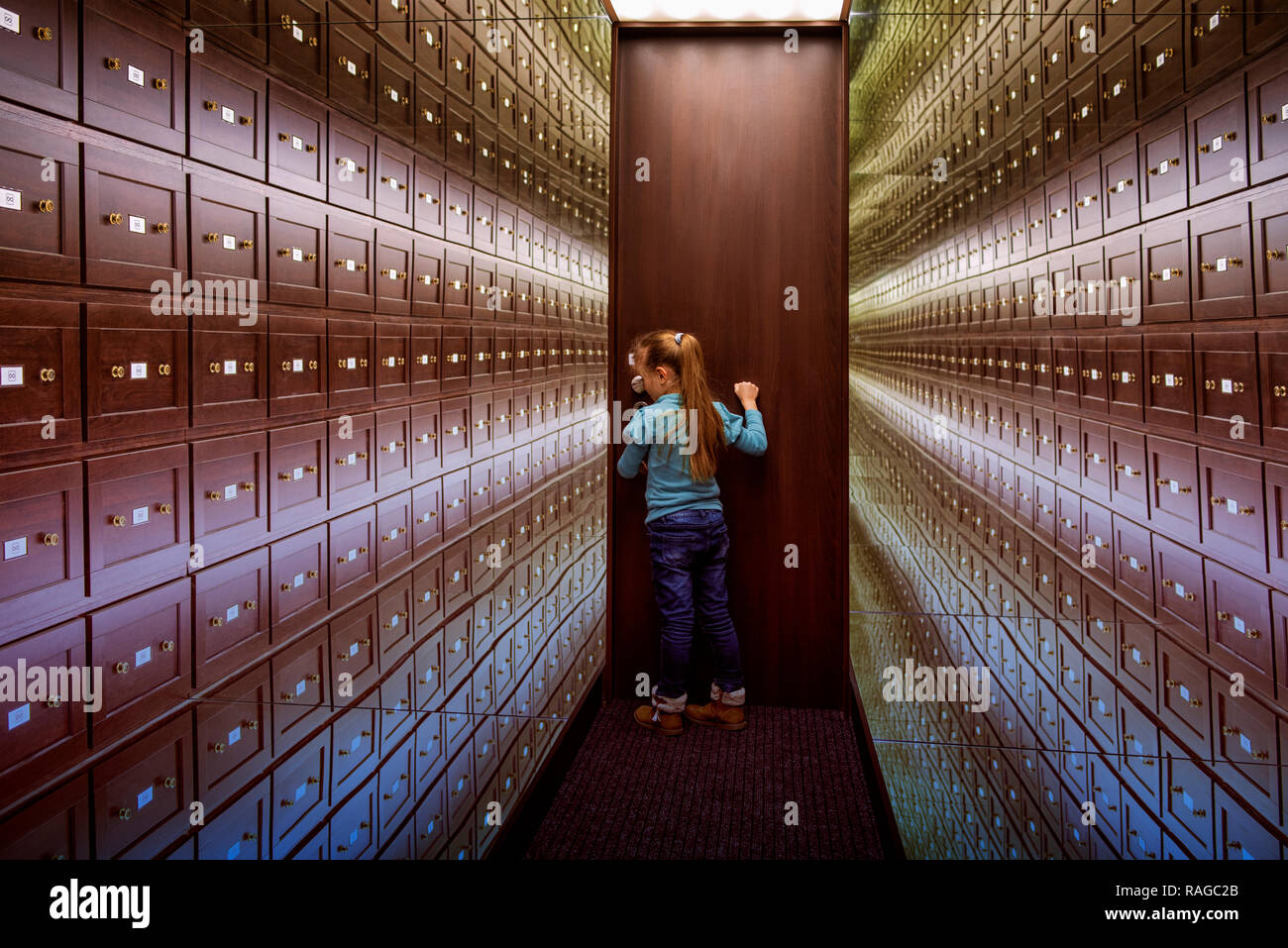 Mirror room illusions.A little girl stands in the room of illusions ...