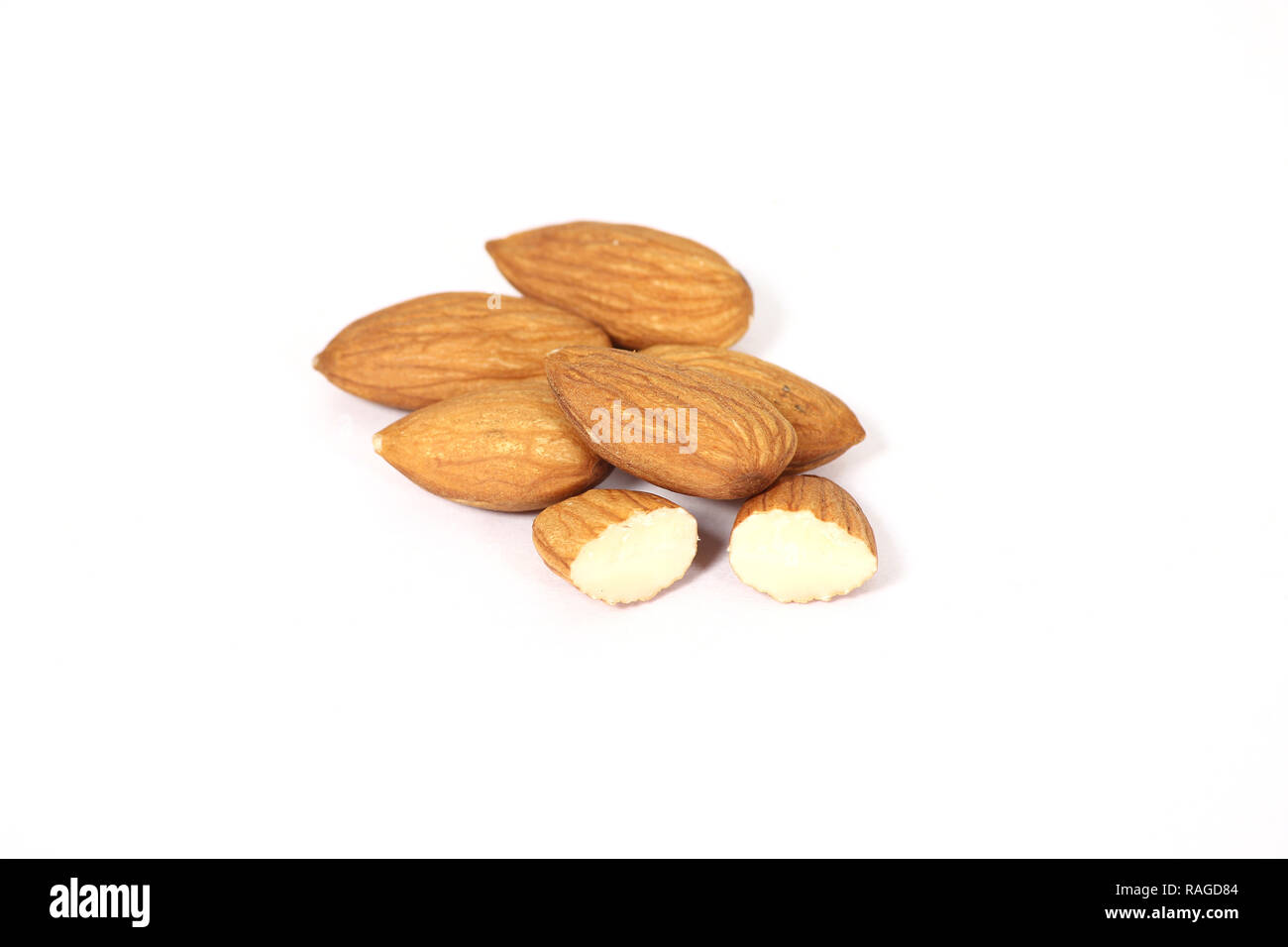 Almond In White Background Isolated and Broken Stock Photo - Alamy