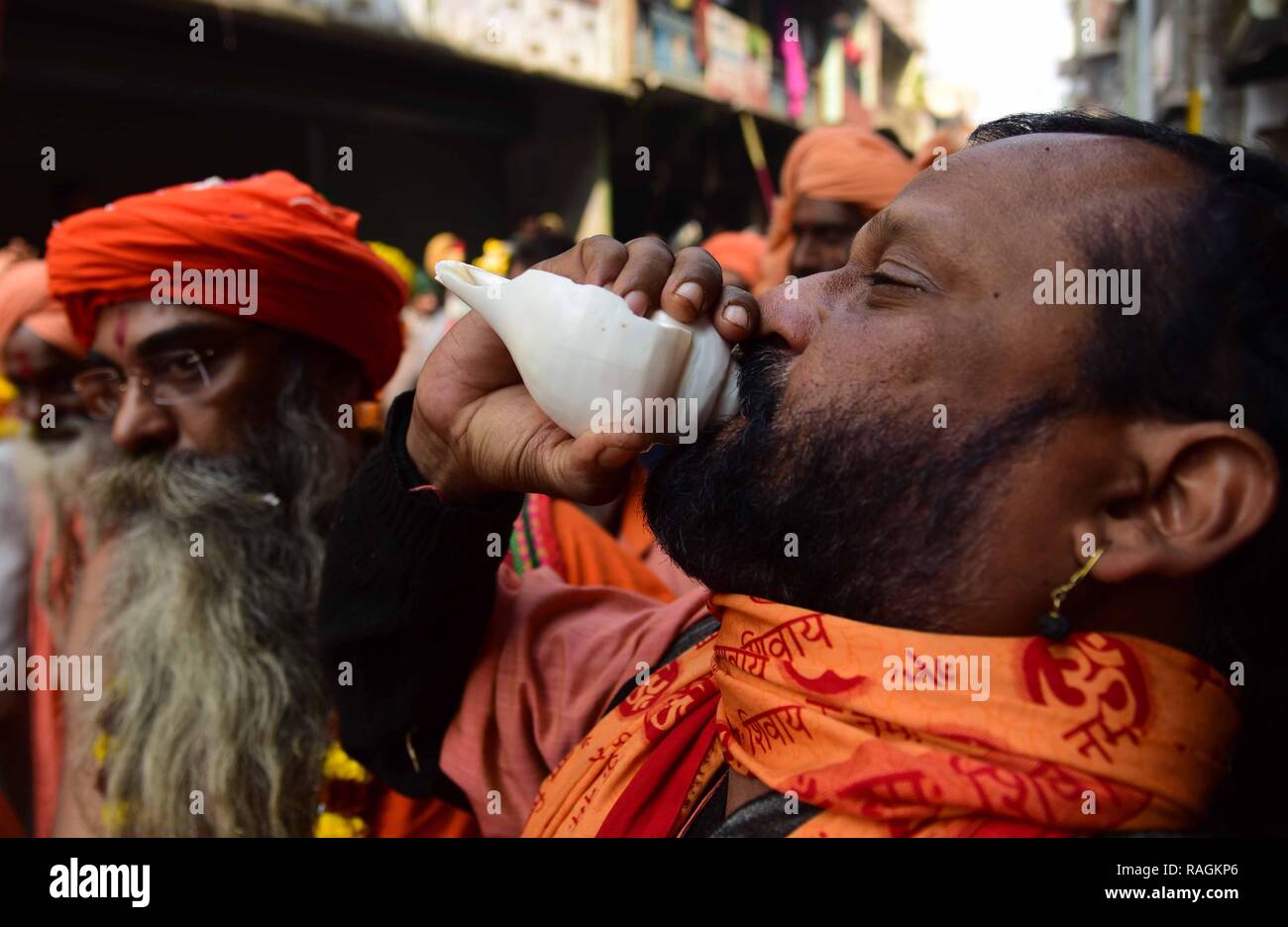 Allahabad, India. 03rd Jan, 2019. A devotee blowing conch shell as ...