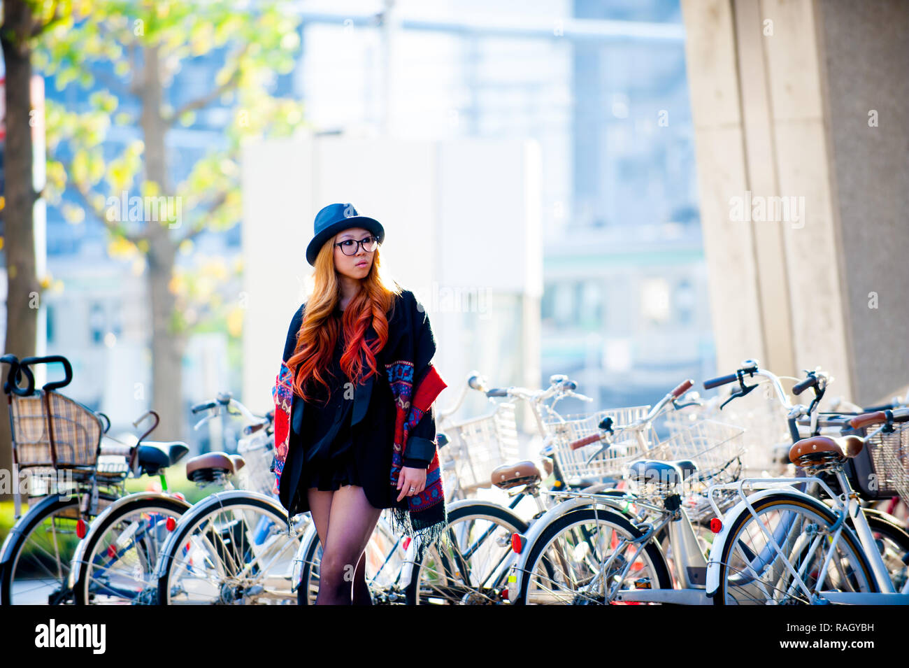 Asian female model poses for pictures on the street Stock Photo - Alamy