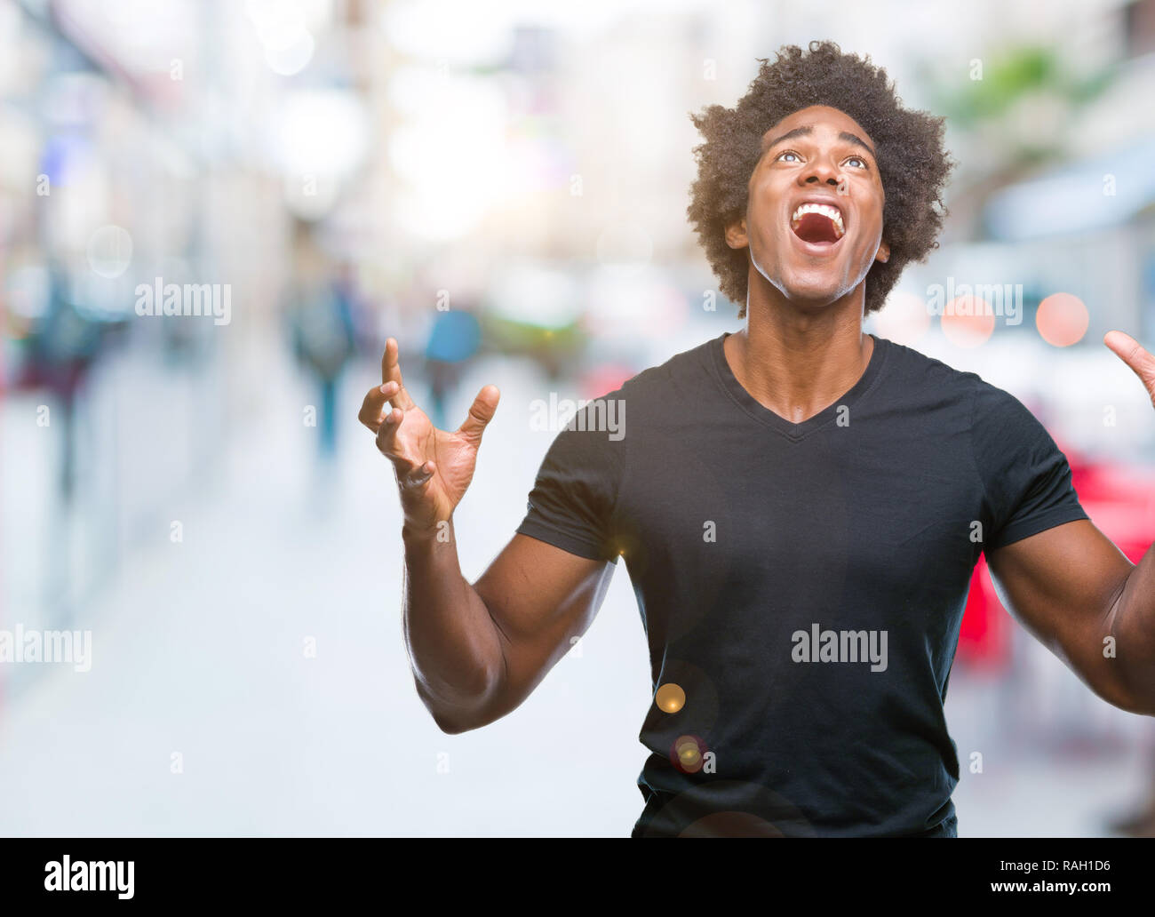 Afro american man over isolated background crazy and mad shouting and ...