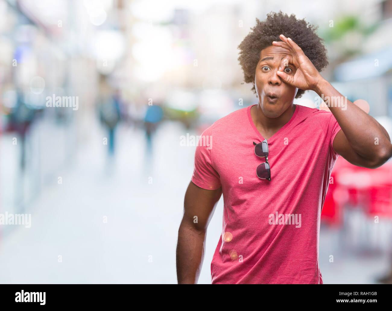 Afro american man over isolated background doing ok gesture shocked ...