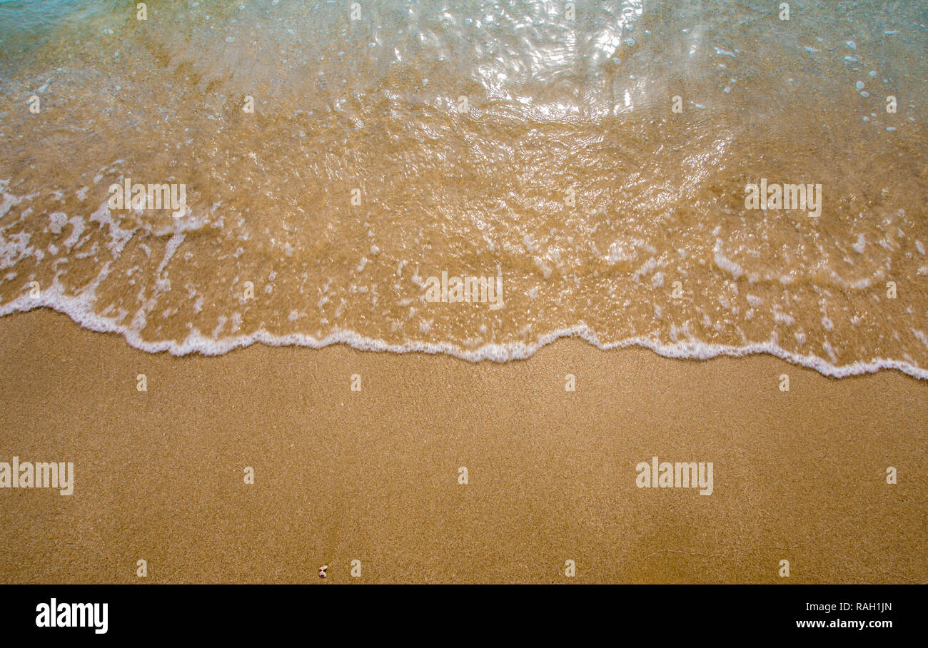 White bubble of Sea wave on fine sand at the beach Stock Photo - Alamy