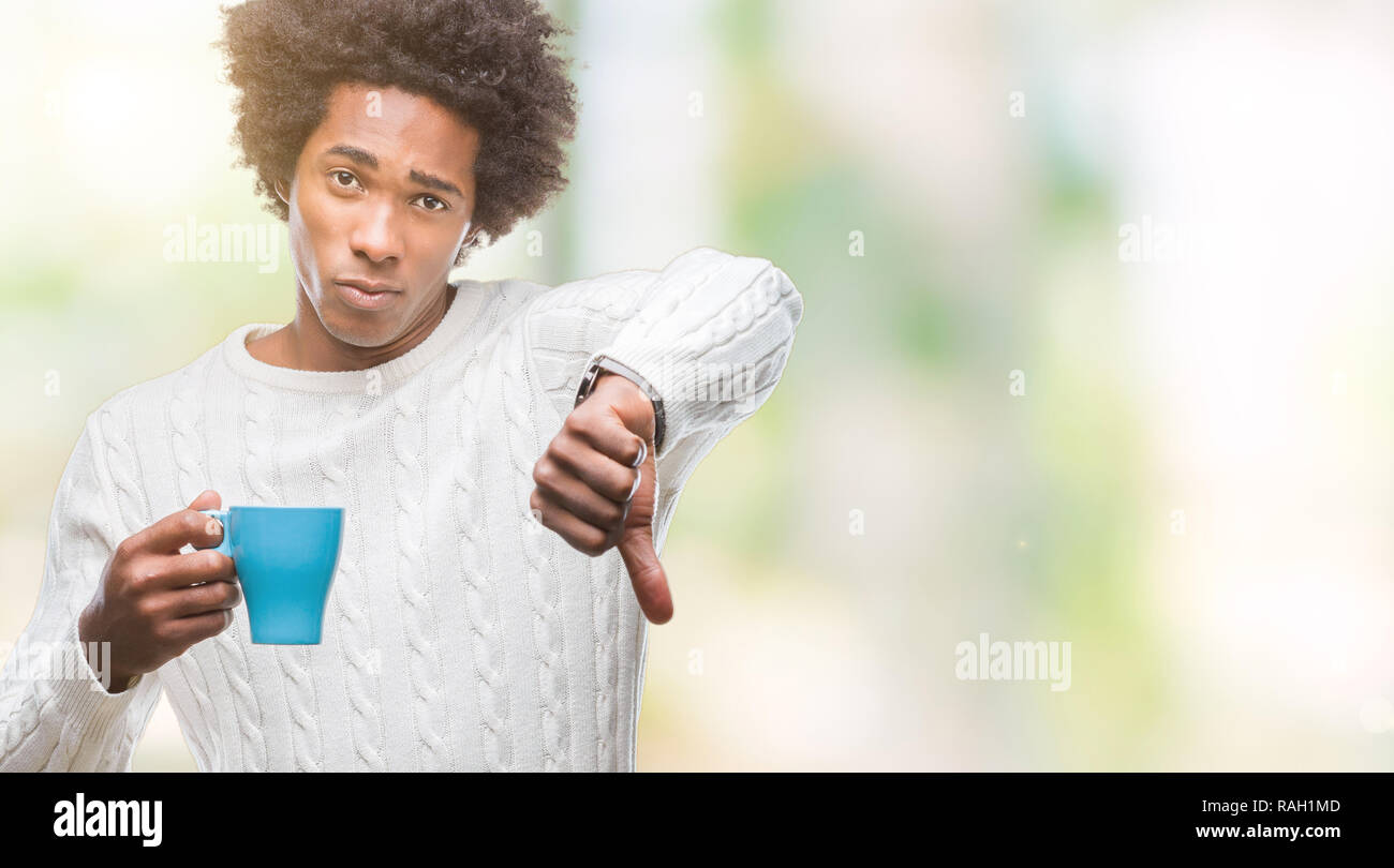Afro american man drinking cup of coffee over isolated background with ...
