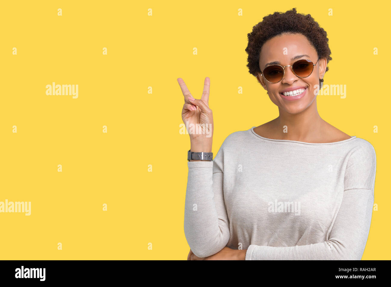 Beautiful young african american woman wearing sunglasses over isolated ...
