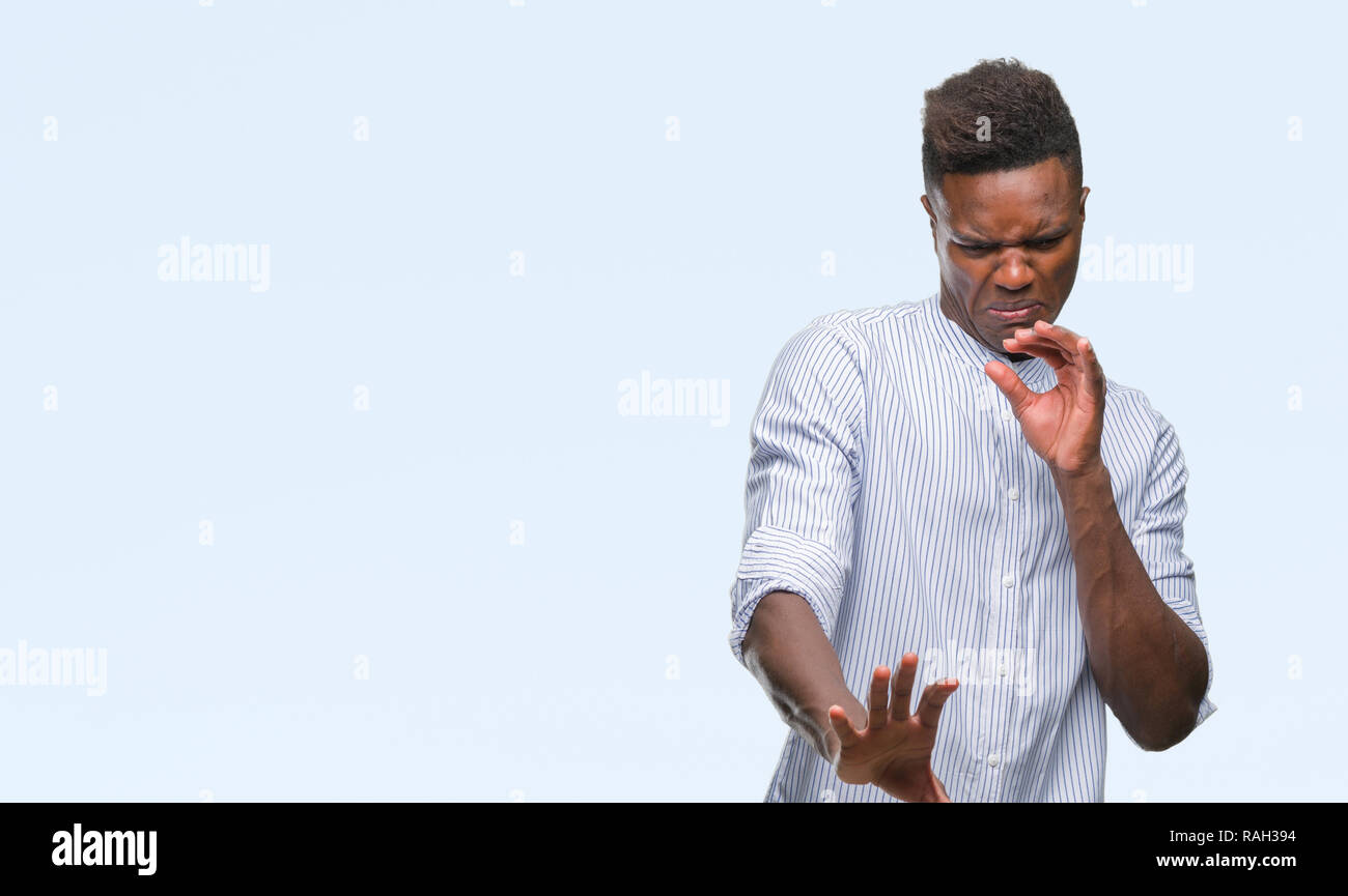 Young african american man over isolated background disgusted ...
