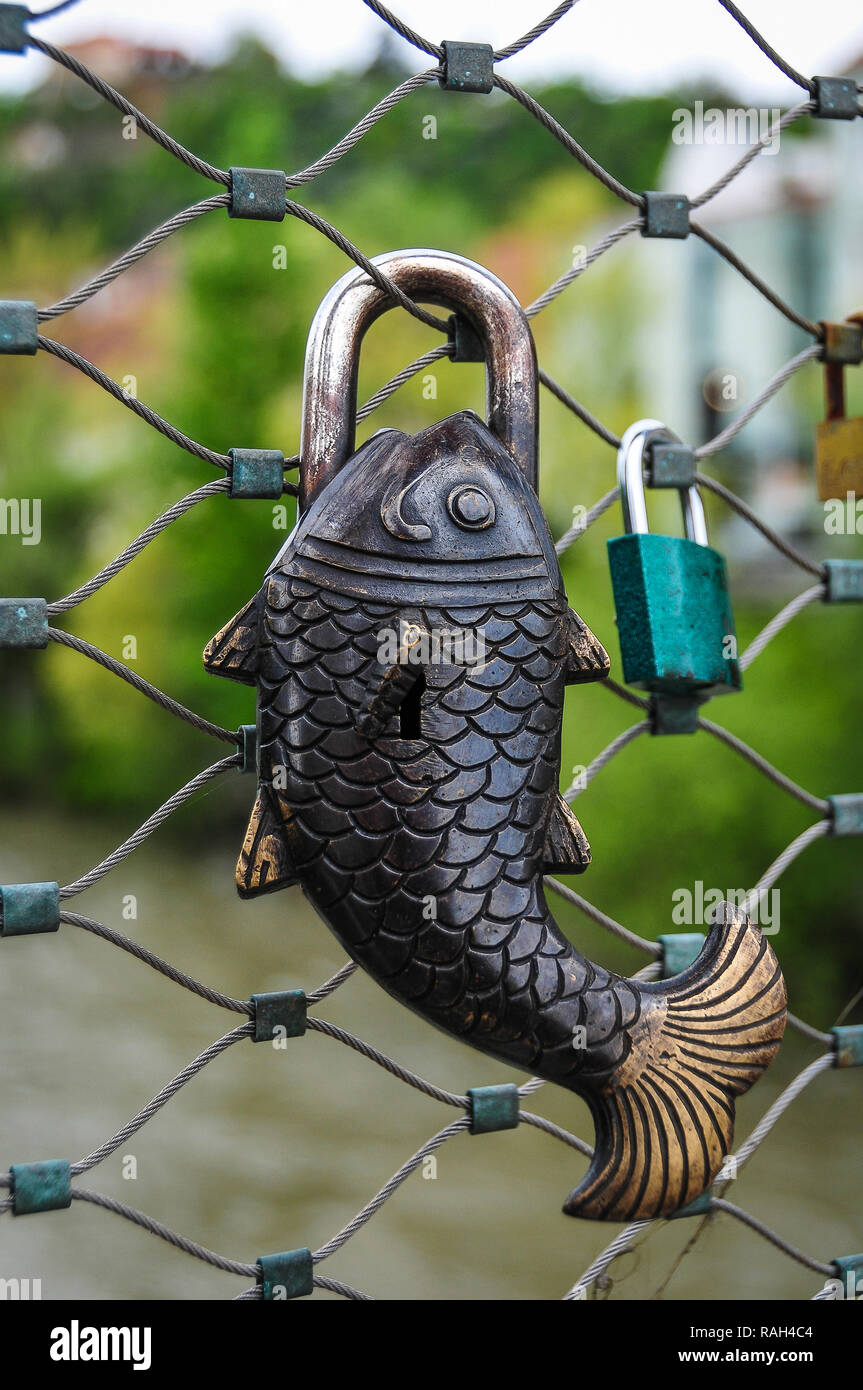 Fish lock on fence of bridge, a lock in the form of a fish on a bridge ...