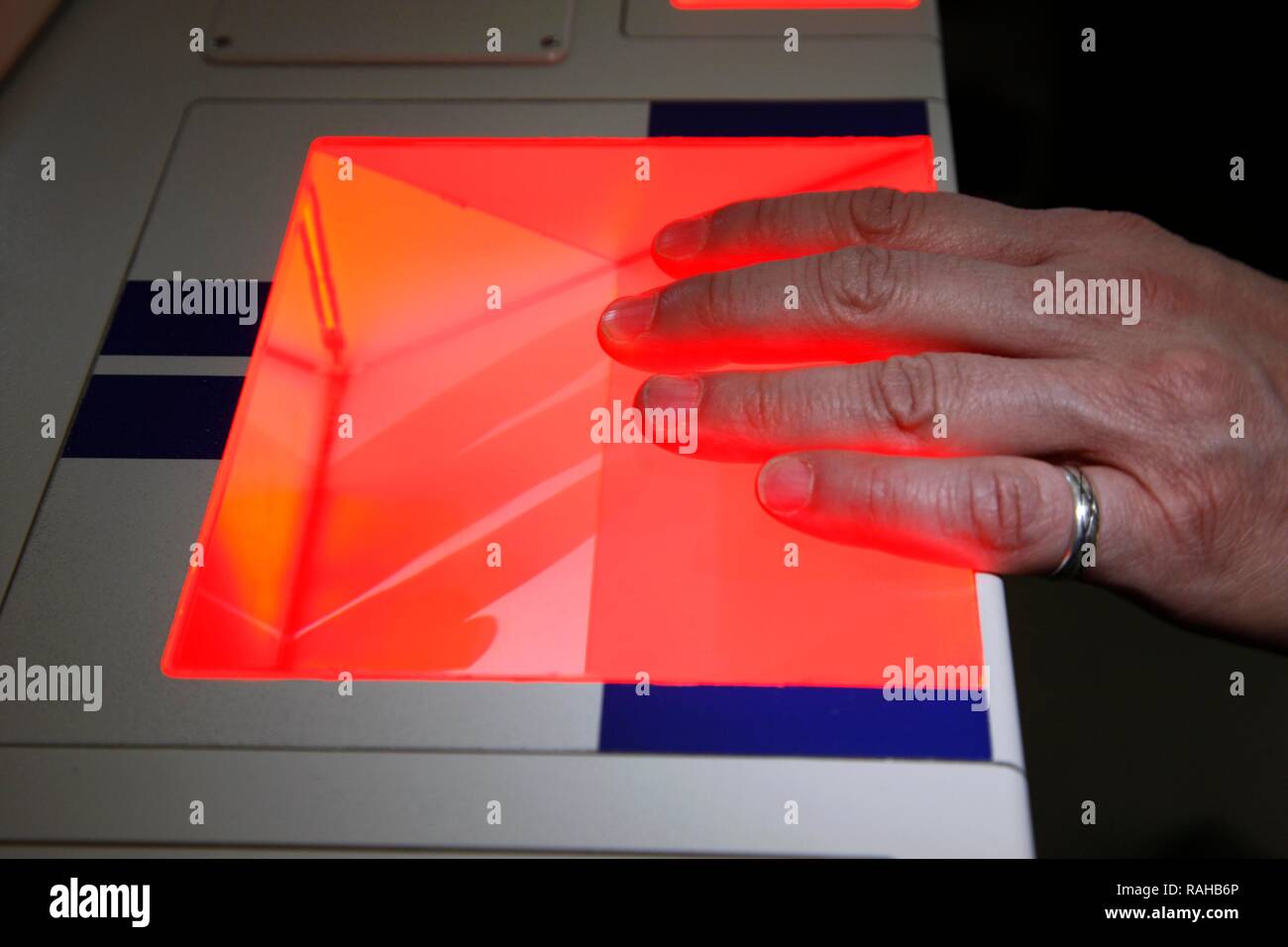 A suspect's fingerprints are taken at the police, scanning of ...