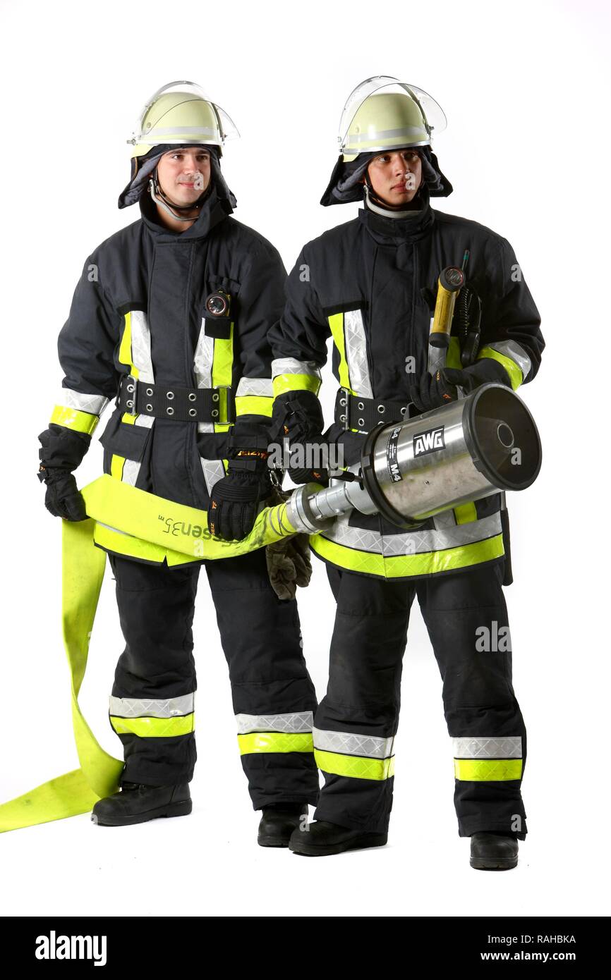 Firefighters from a fire-fighting crew holding a foam pipe for ...