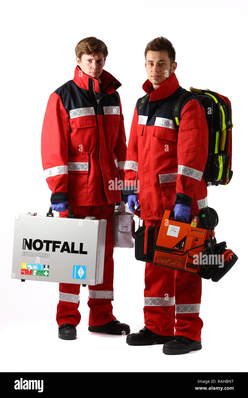 Paramedics with emergency equipment, first aid kit with bandages ...