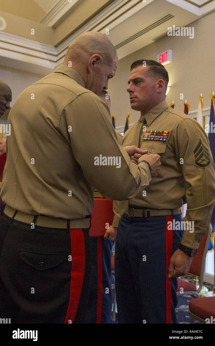 Commandant of the Marine Corps Gen. Robert B. Neller, left, pins a Navy ...