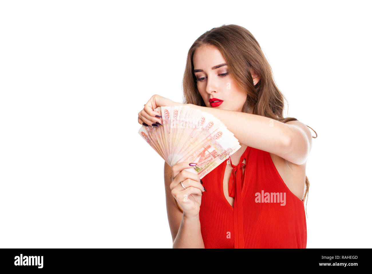 Russian rubles. Young happy woman holding a fan of money, isolated over ...