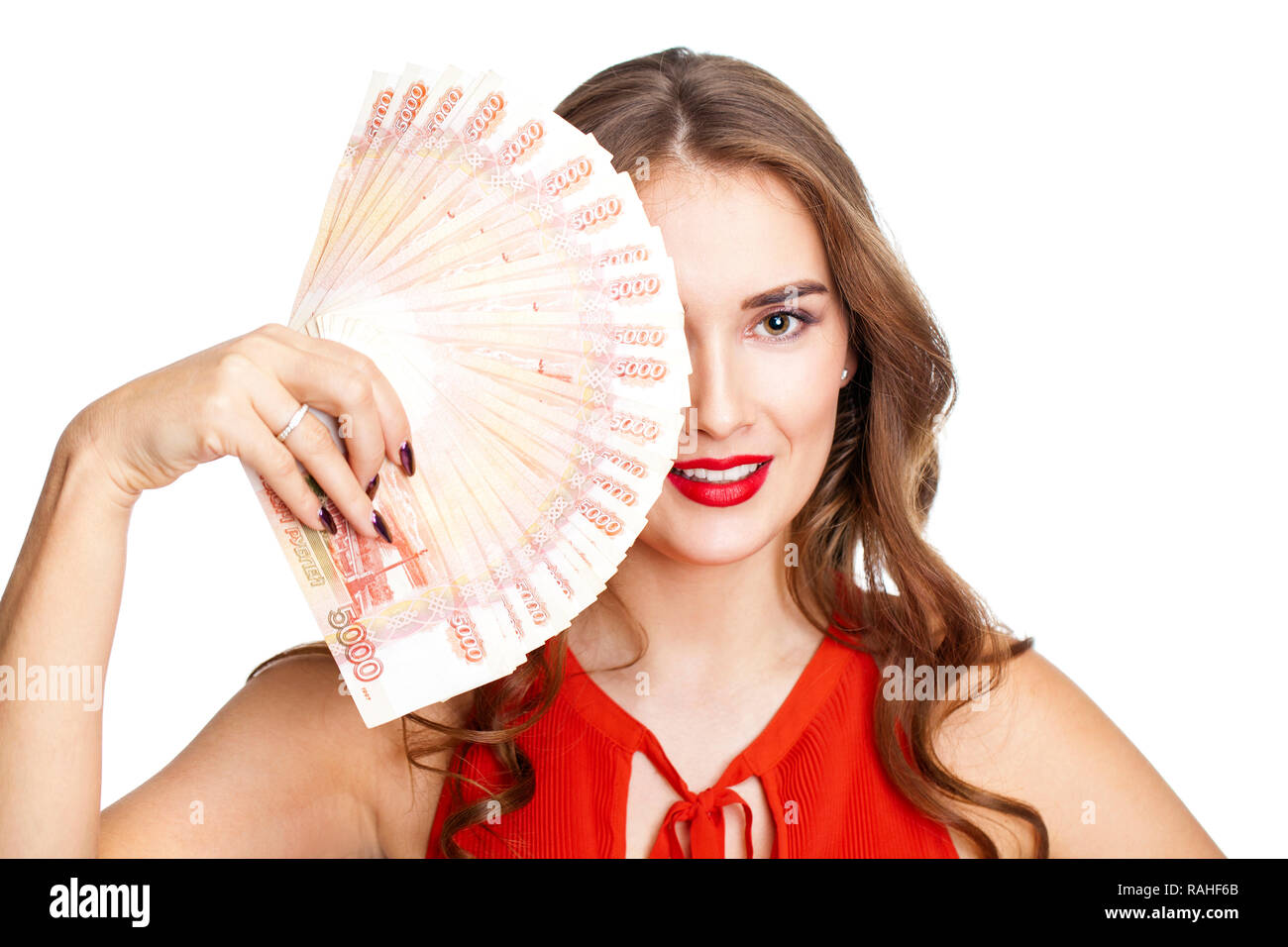 Russian rubles. Young happy woman holding a fan of money, isolated over ...