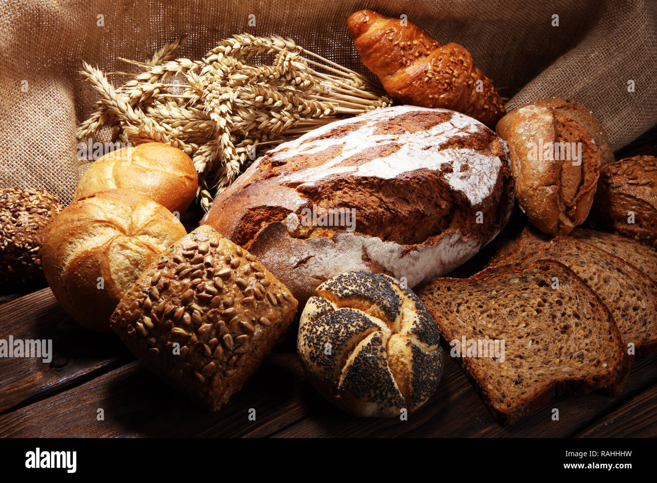 Different kinds of bread and bread rolls on board from above. Kitchen ...