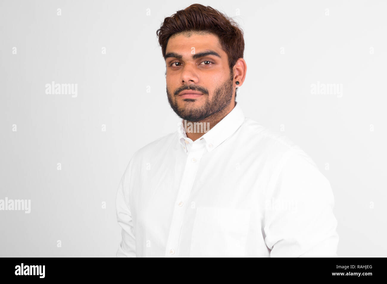 Young handsome bearded Indian man against white background Stock Photo ...
