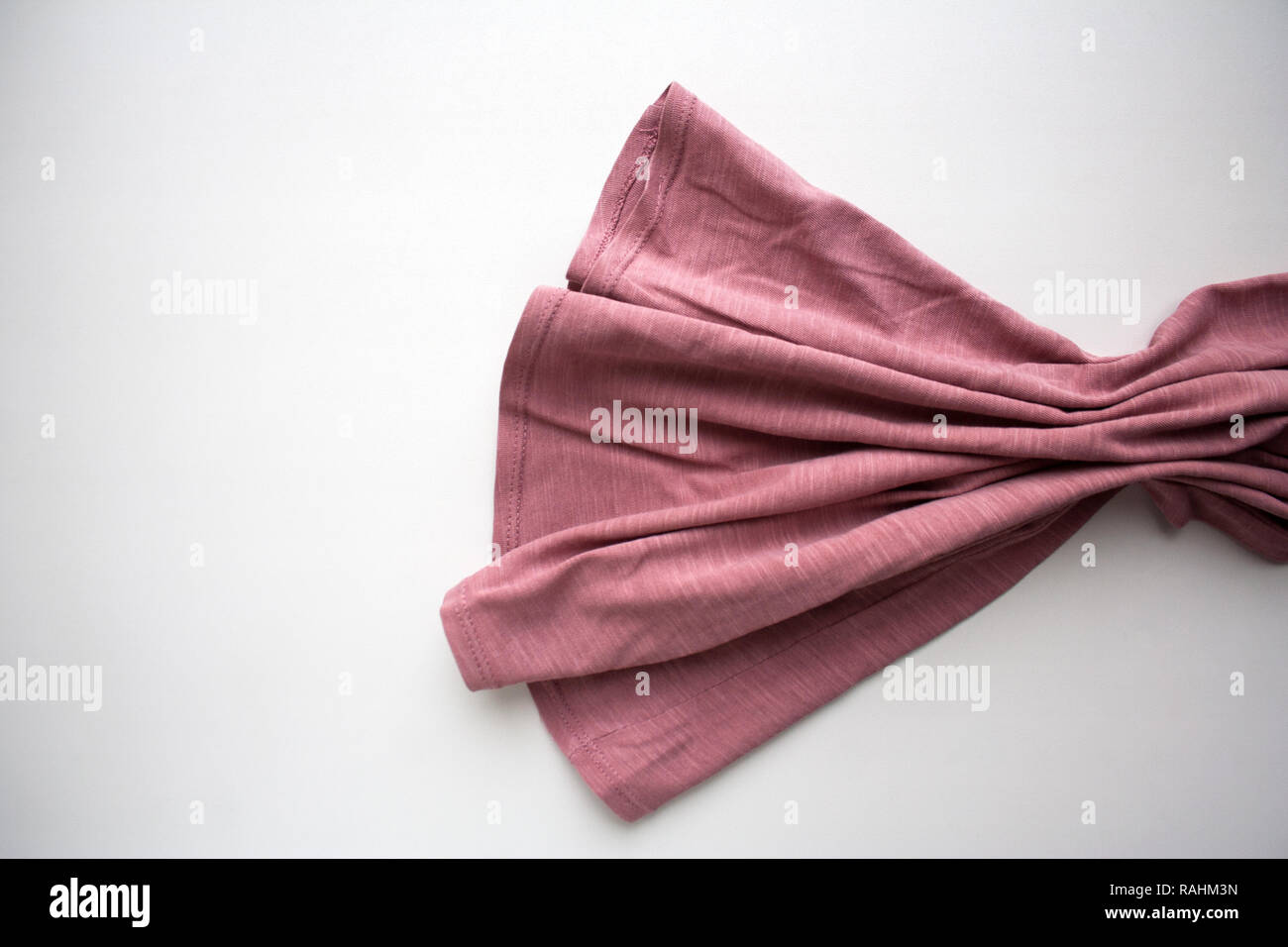 Pink folded cotton textile isolated on white background Stock Photo - Alamy