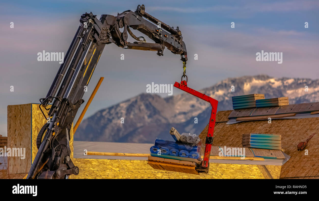 Crane lifting building materials on home construction in Daybreak Utah ...