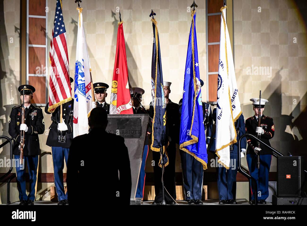 A Joint Service Honor Guard team presents the American Flag as well as ...