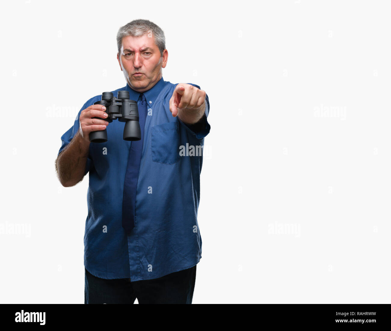 Handsome senior man looking through binoculars over isolated background ...