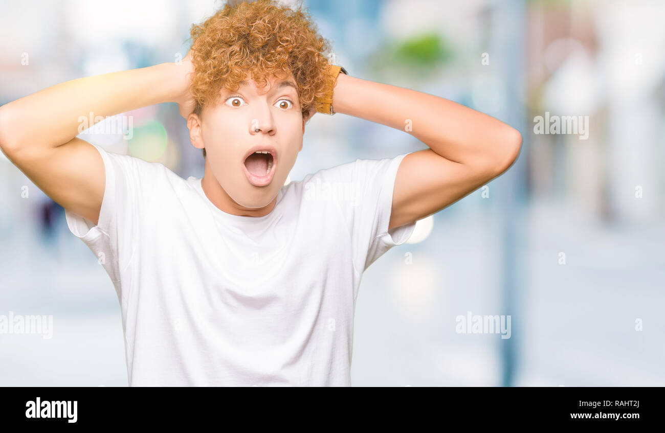 Young handsome man with afro hair wearing casual white t-shirt Crazy ...
