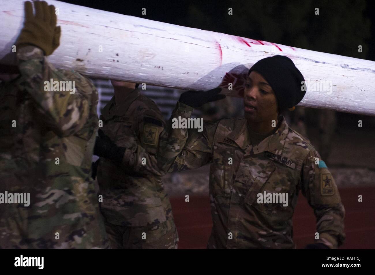 A soldier from the 344th Military Intelligence Battalion carries a log ...
