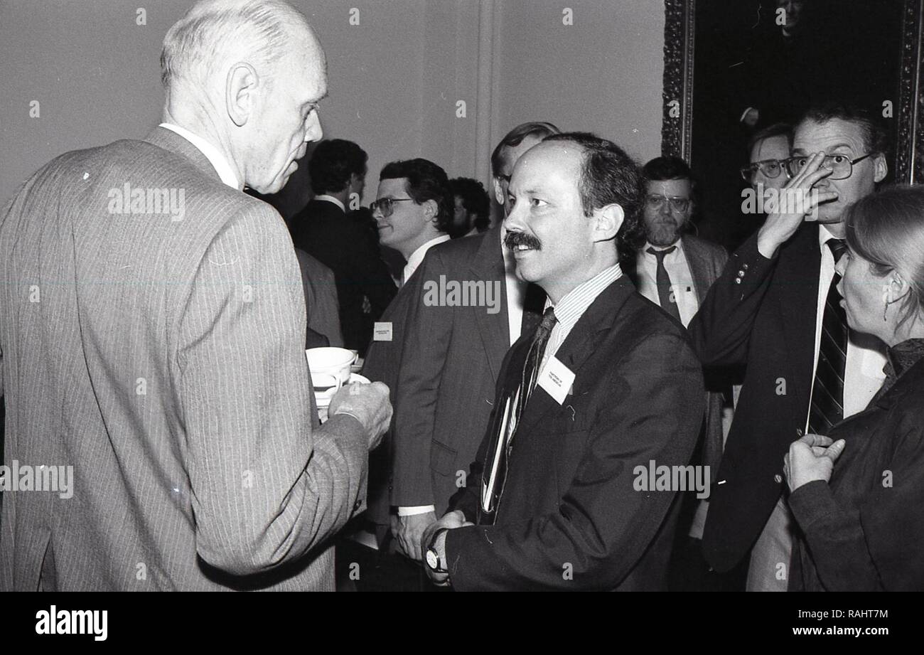 THREE MEN ARE GREETING EACH OTHER AT A EVENT Stock Photo - Alamy