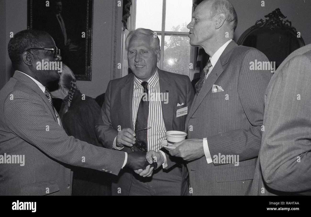 THREE MEN ARE GREETING EACH OTHER AT A EVENT Stock Photo - Alamy