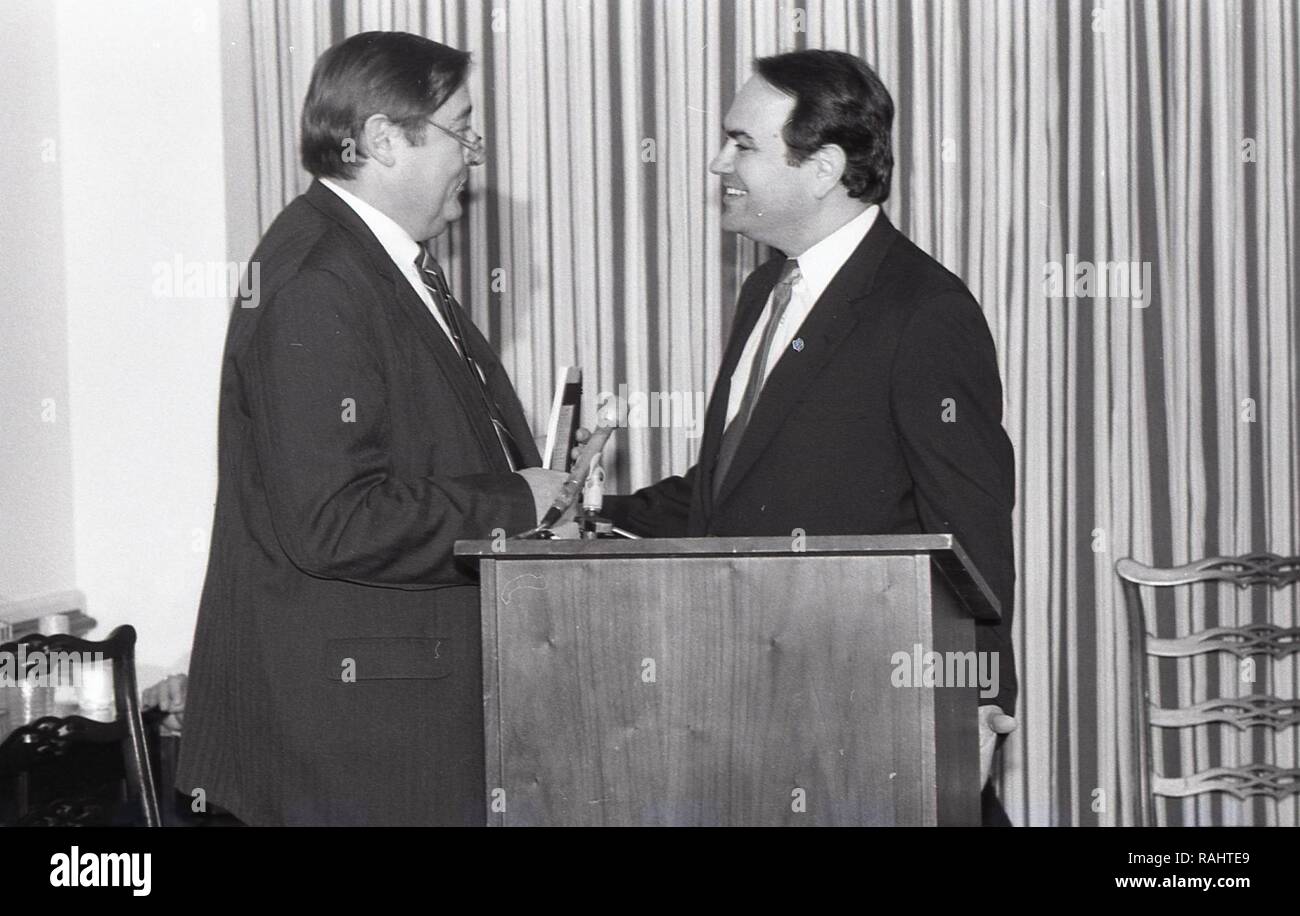 TWO MEN ARE AT THE PODIUM GREETING EACH OTHER Stock Photo - Alamy
