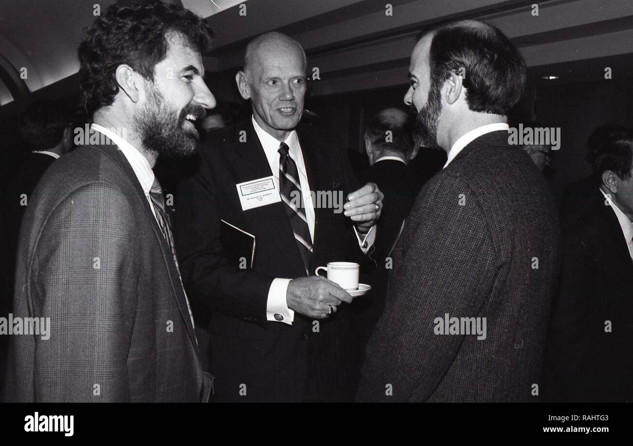 THREE MEN ARE HAVING A CONVERSATION Stock Photo - Alamy