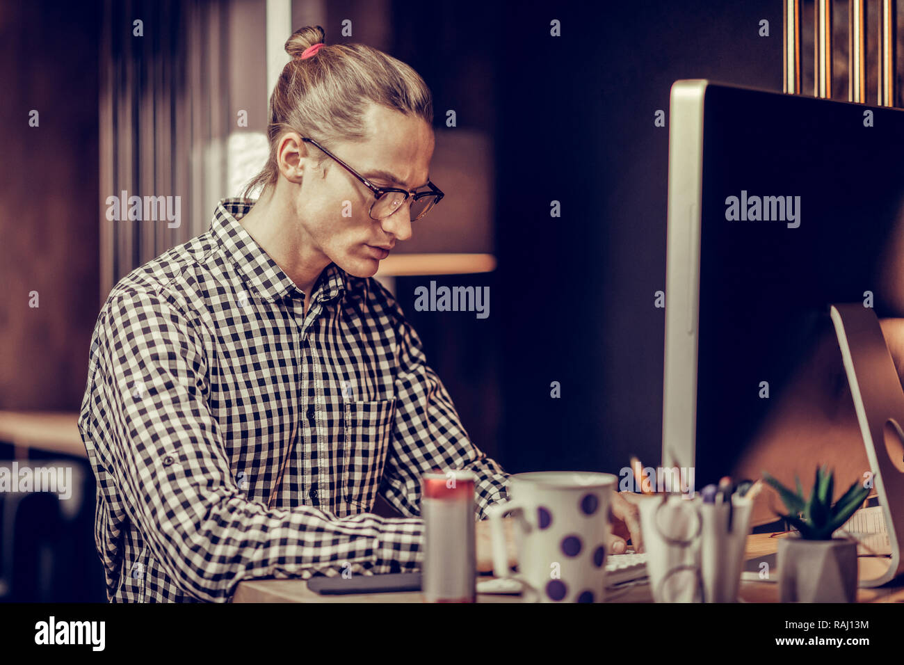 Concentrated male person typing text on his computer Stock Photo - Alamy