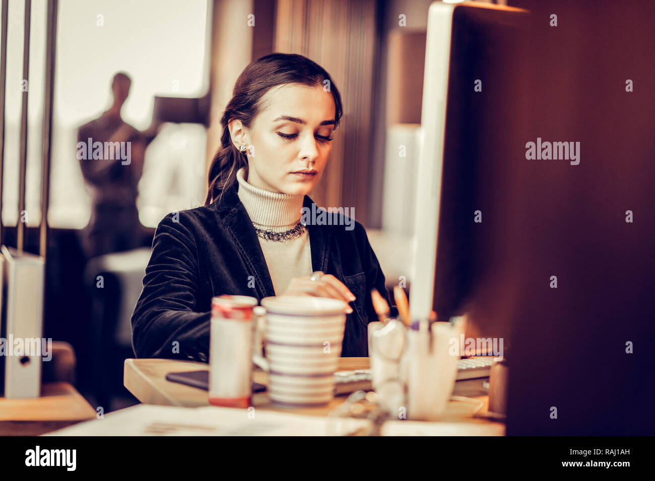Attentive young brunette female typing message for partner Stock Photo ...