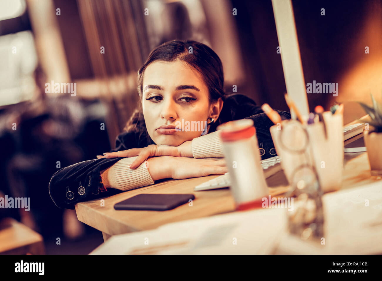 Low spirited female dreaming about summer vacation Stock Photo - Alamy